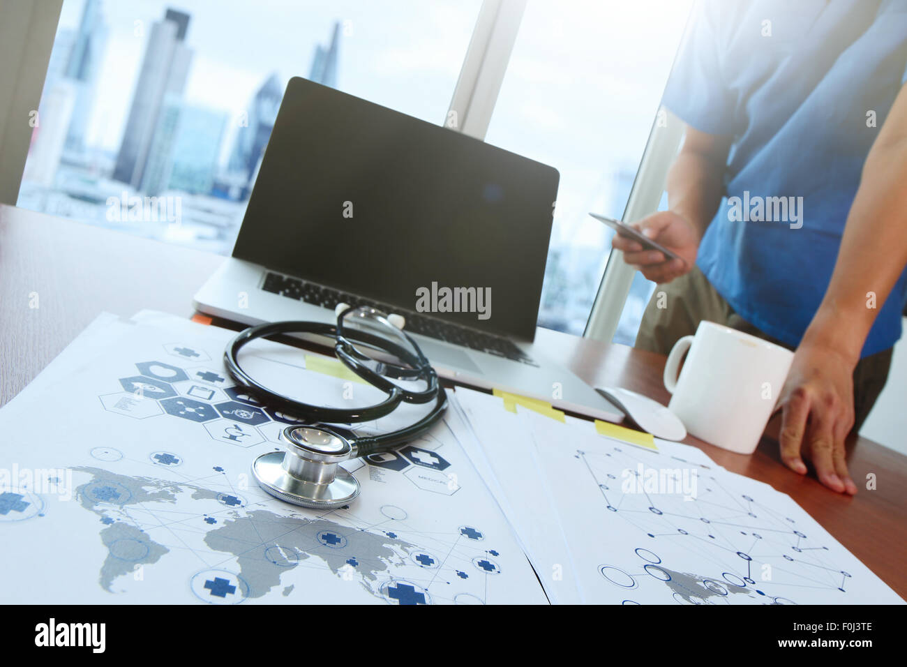 Doctor working with laptop computer in medical workspace office and ...