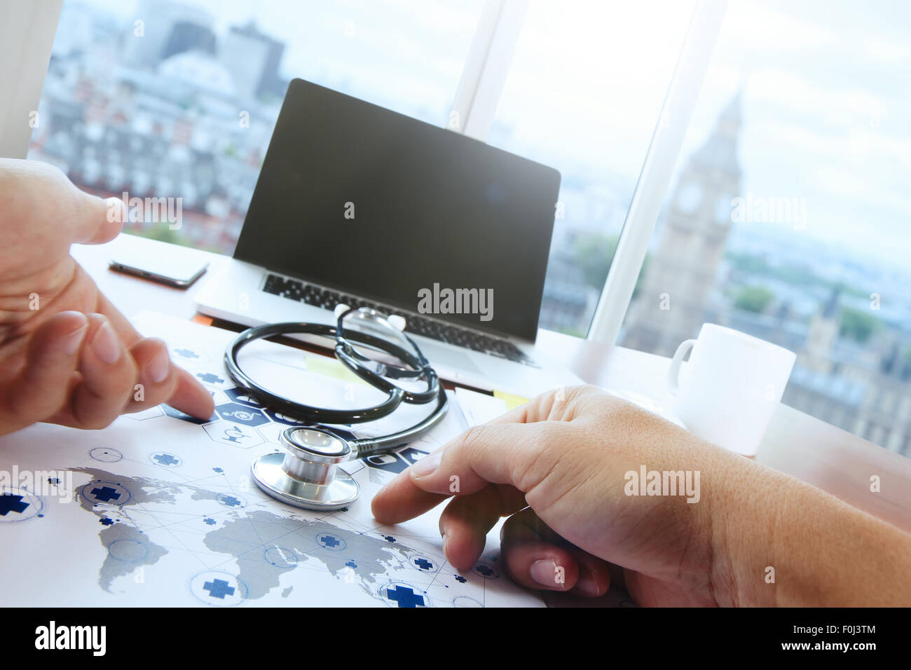Doctor working with laptop computer in medical workspace office and ...