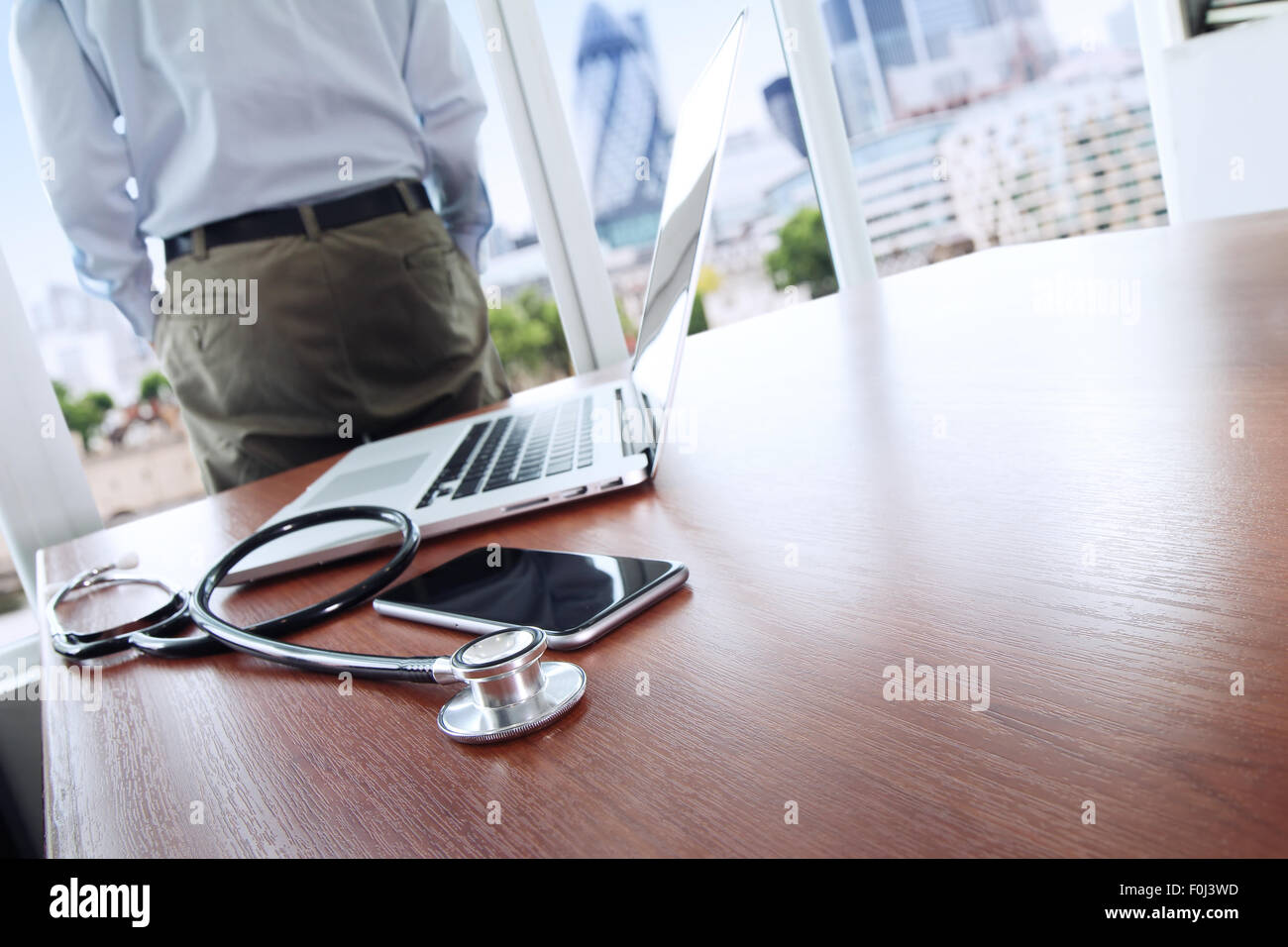 Doctor working with laptop computer in medical workspace office and ...