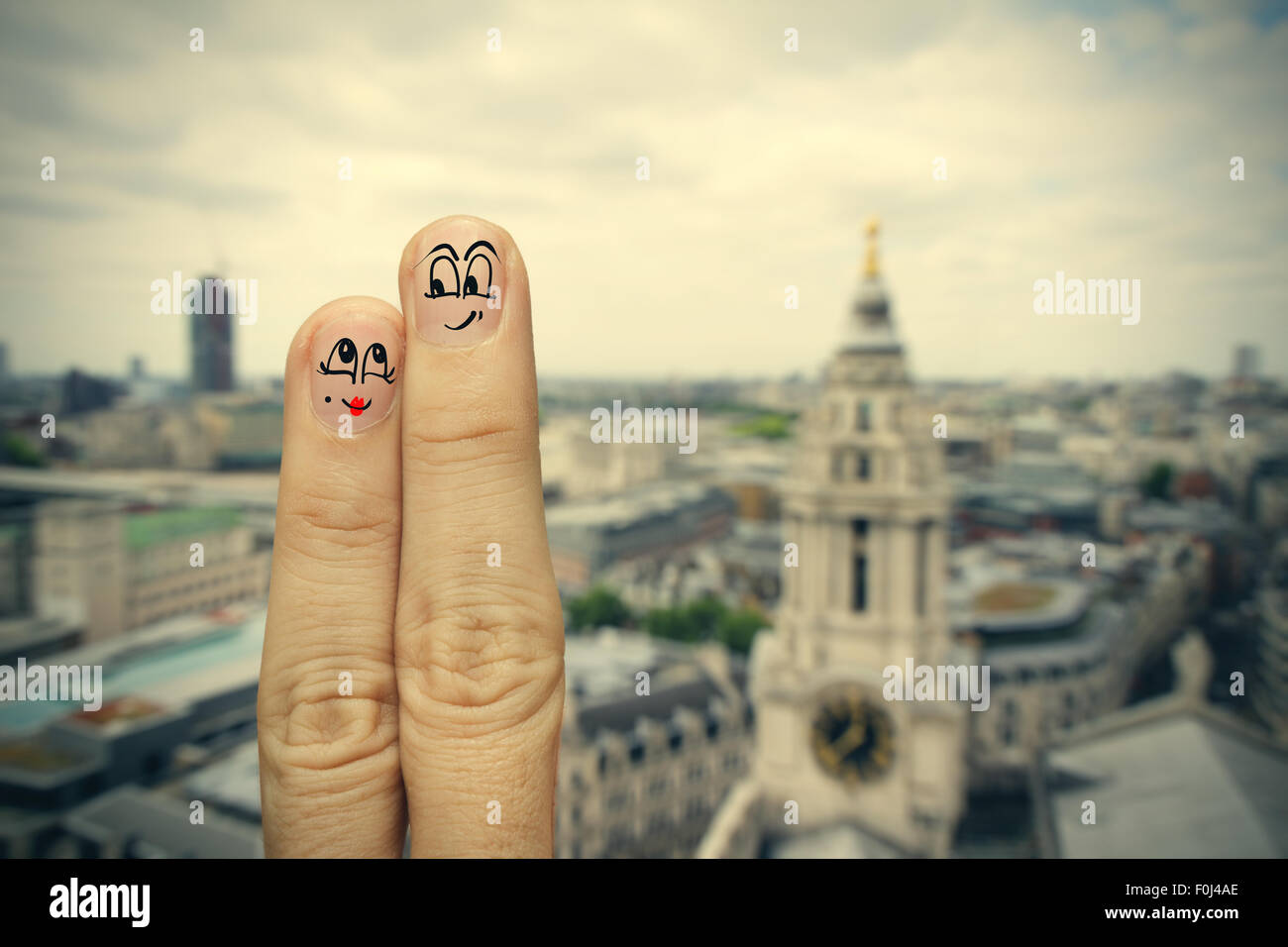 the happy finger couple in love with painted smiley on london city ...