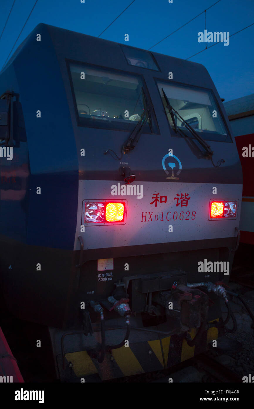 Modern locomotive of train at night in a train station in China. China ...