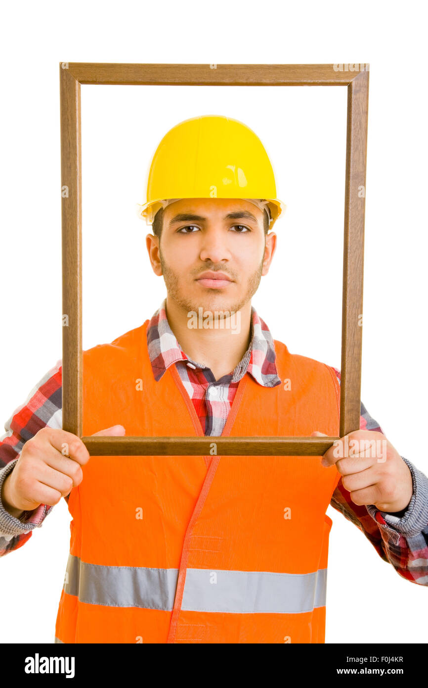 Construction worker looking through an empty picture frame Stock Photo ...