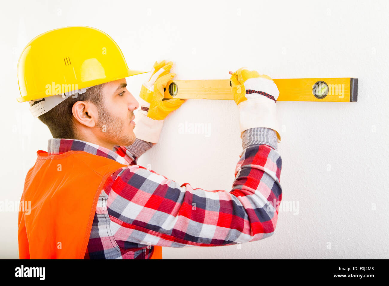 Manual worker using an air level to draw a straight line Stock Photo ...
