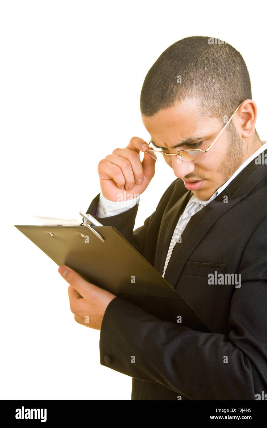Sceptical manager with glasses looking at clipboard Stock Photo - Alamy