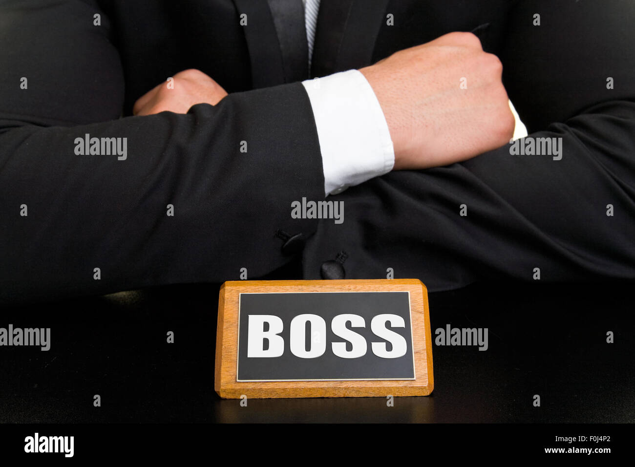 Manager with arms crossed and sign saying "BOSS Stock Photo - Alamy