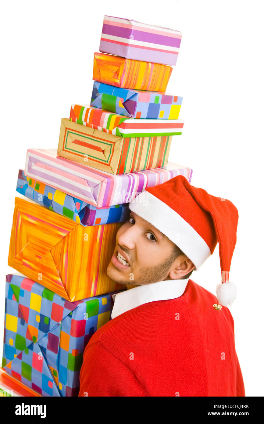Young worried man balancing stack of christmas gifts Stock Photo - Alamy