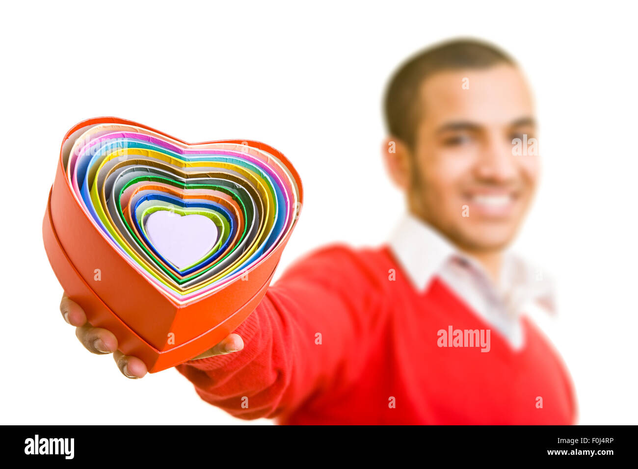 Young smiling man holding many colorful heart-shaped boxes Stock Photo ...