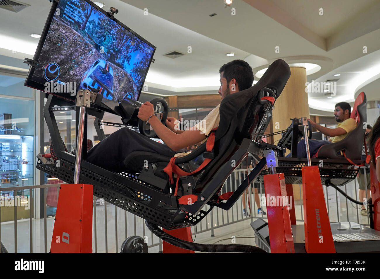 Virtual reality game. Person playing a Virtual Reality motor racing ...