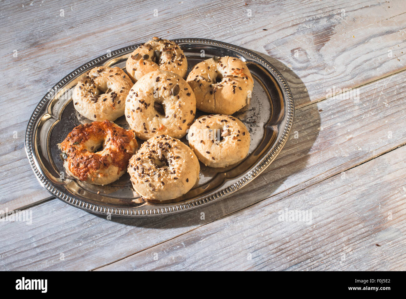 Bagels on a vintage table. Old vintage pan Stock Photo - Alamy