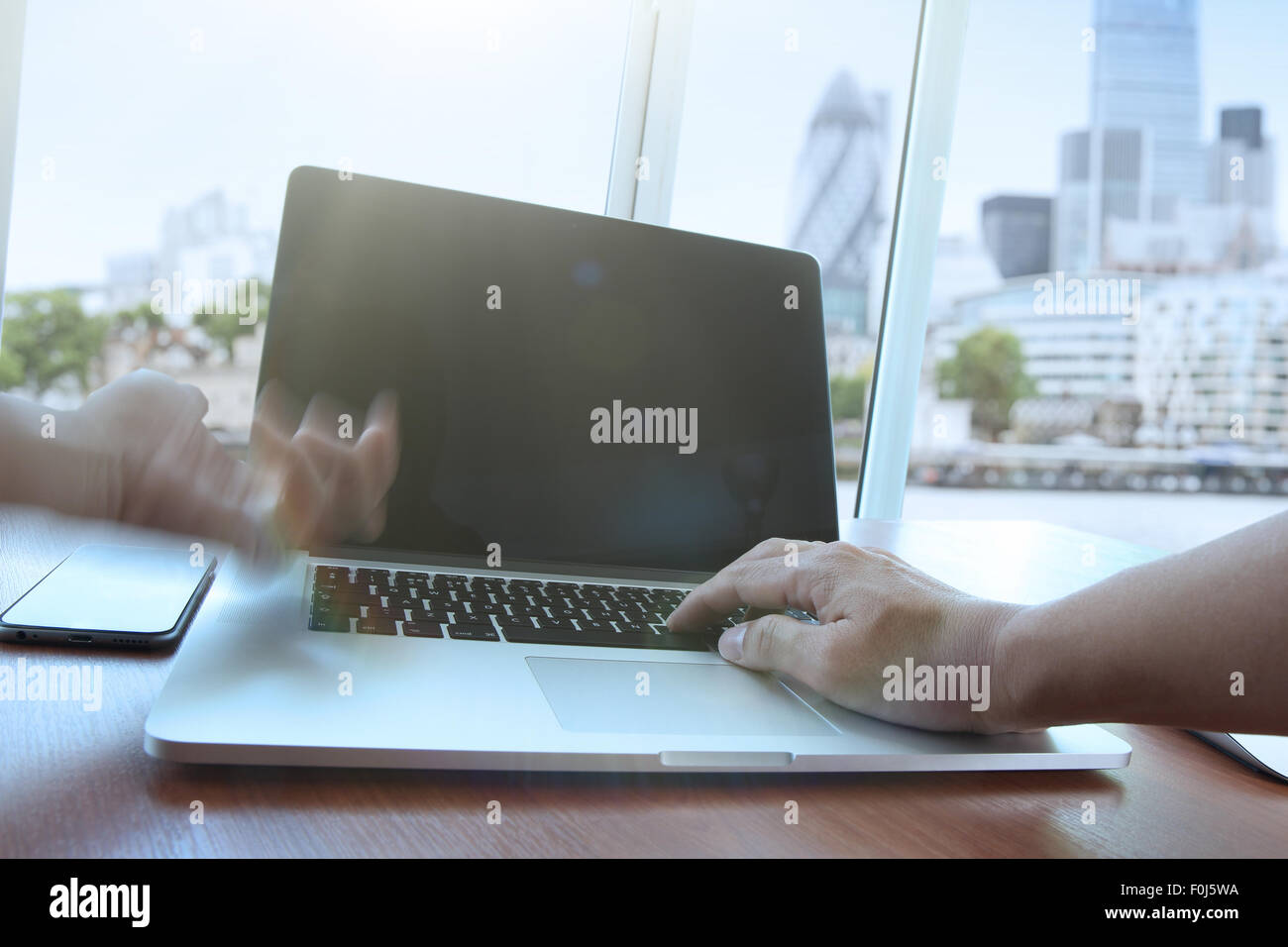 Close up of business man hand working on blank screen laptop computer ...