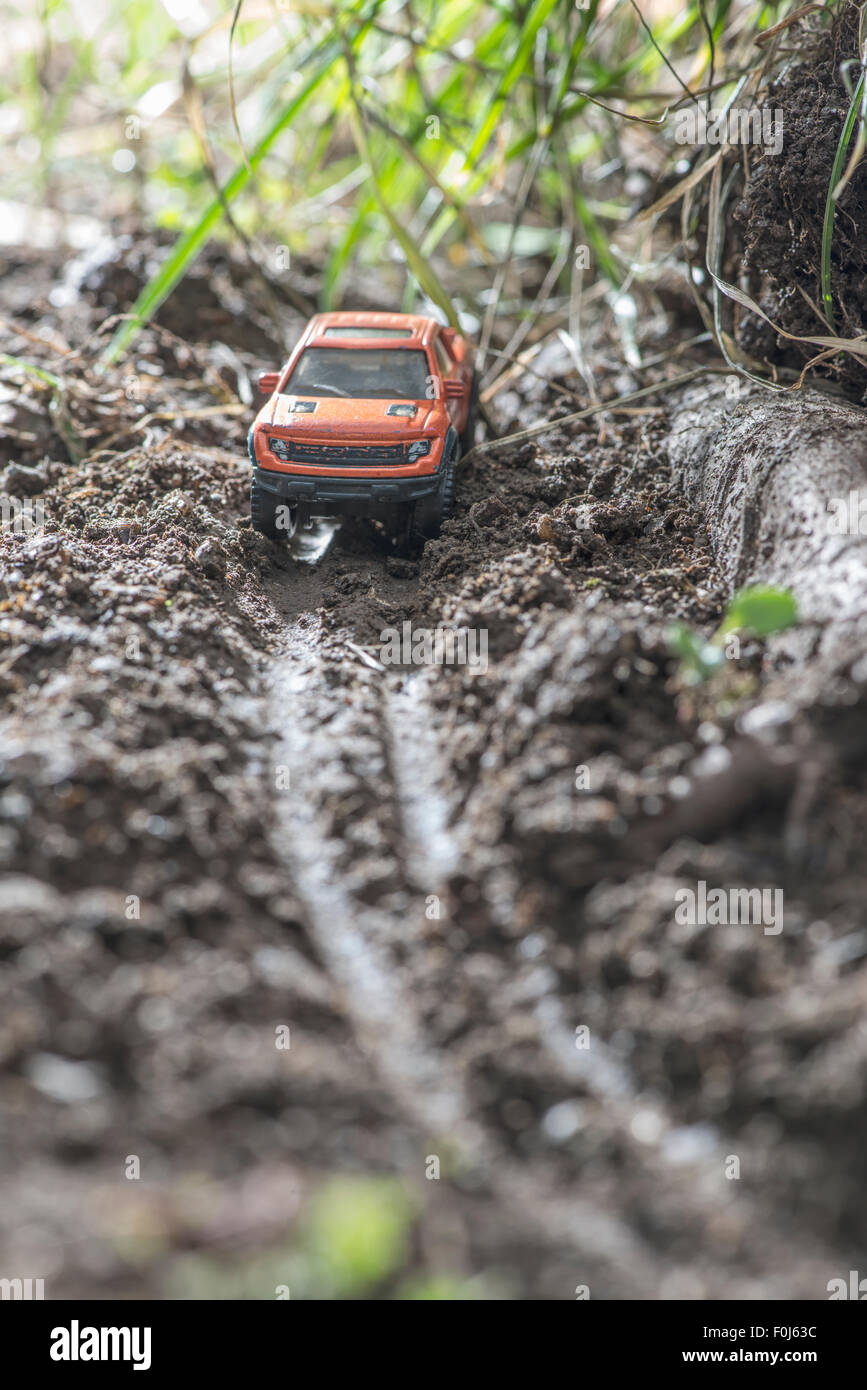 Small red off road car toy in the nature. Miniature Stock Photo - Alamy