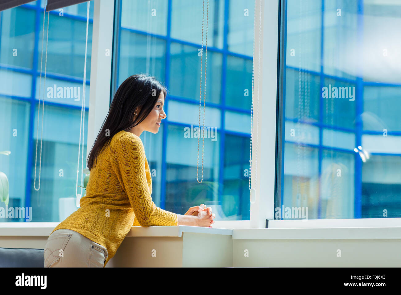 Portrait of a casual businesswoman looking at window in office Stock ...