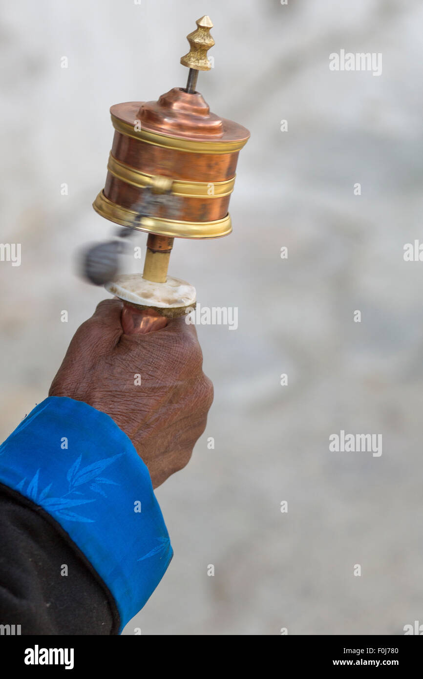 Detail of the hand of an old woman praying with prayer roll at the ...