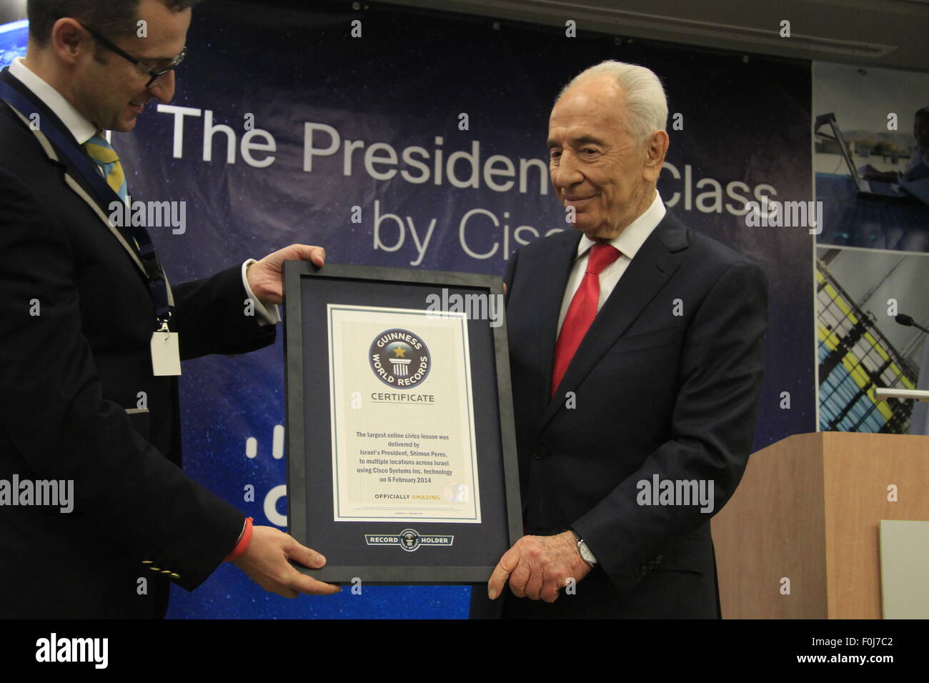 President Peres receives the Guinness World Record Holder card from ...