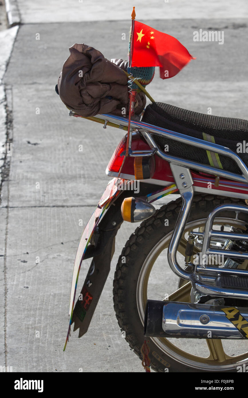 Communist flag at the backside of a bike .The road of Friendship in ...