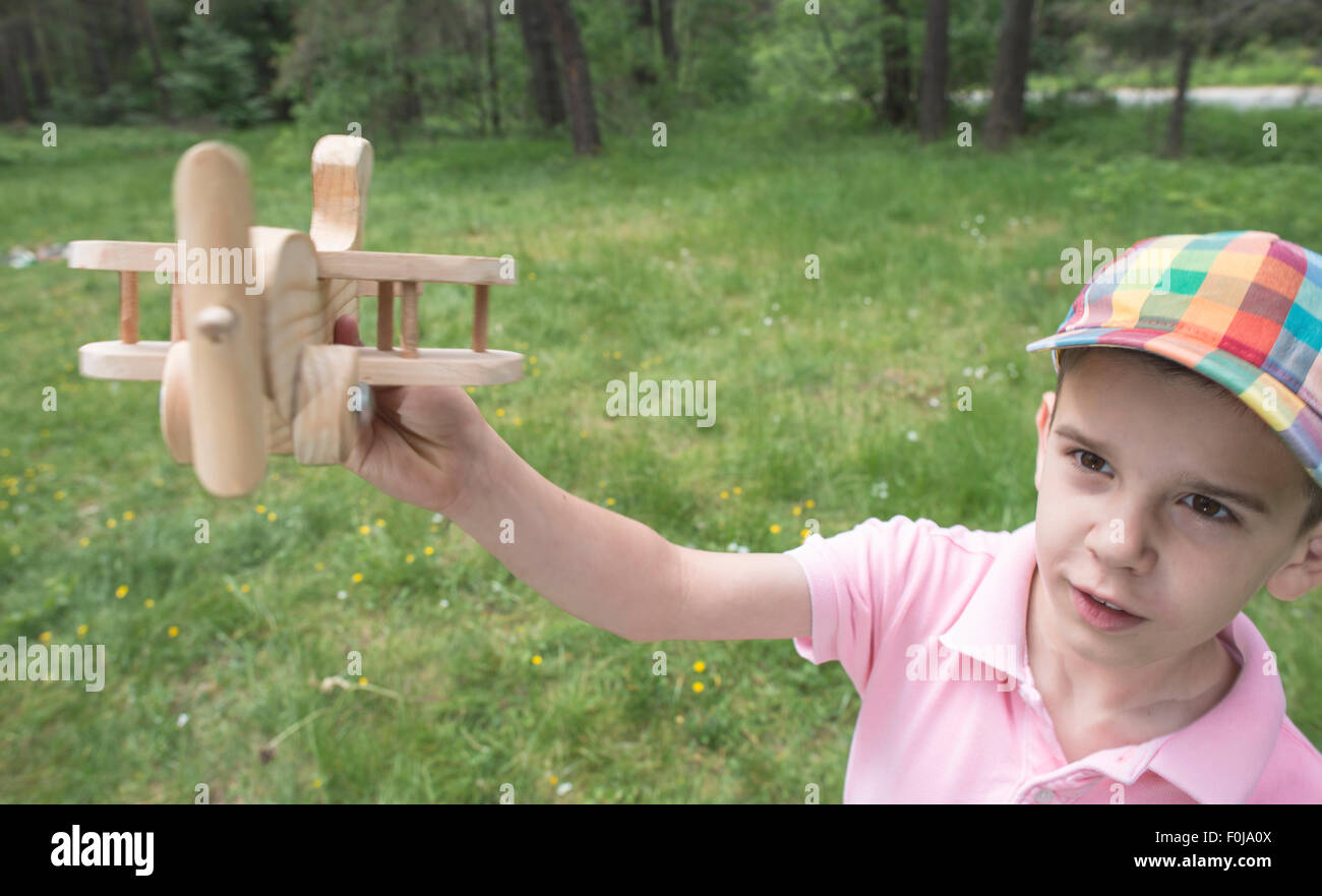 Child play with a wooden plane in the mountain. Forest Stock Photo - Alamy