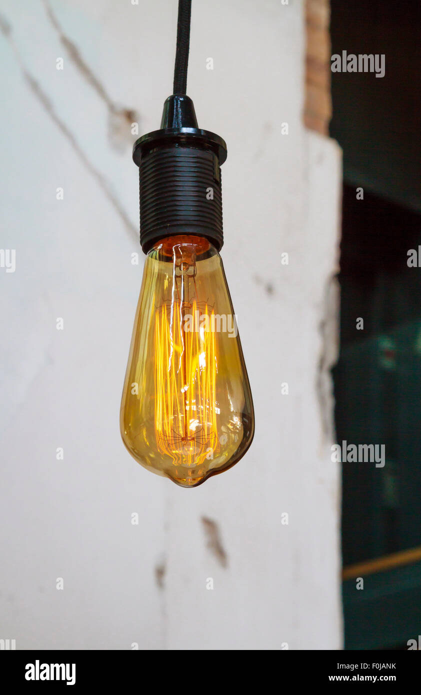 Decorative Edison style light bulb against brick wall background Stock ...