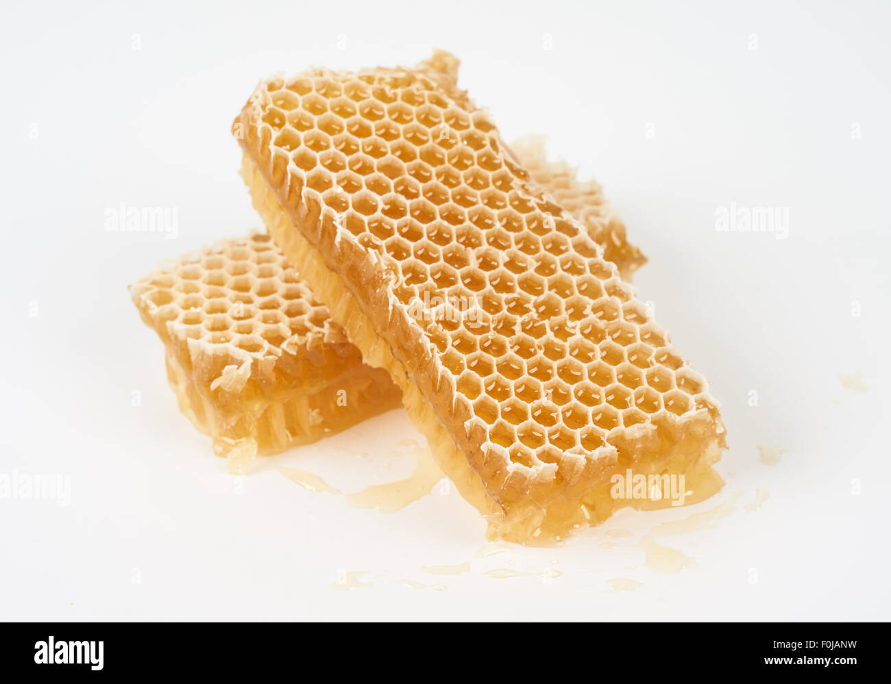 Two slices of raw honeycomb placed on white background Stock Photo - Alamy