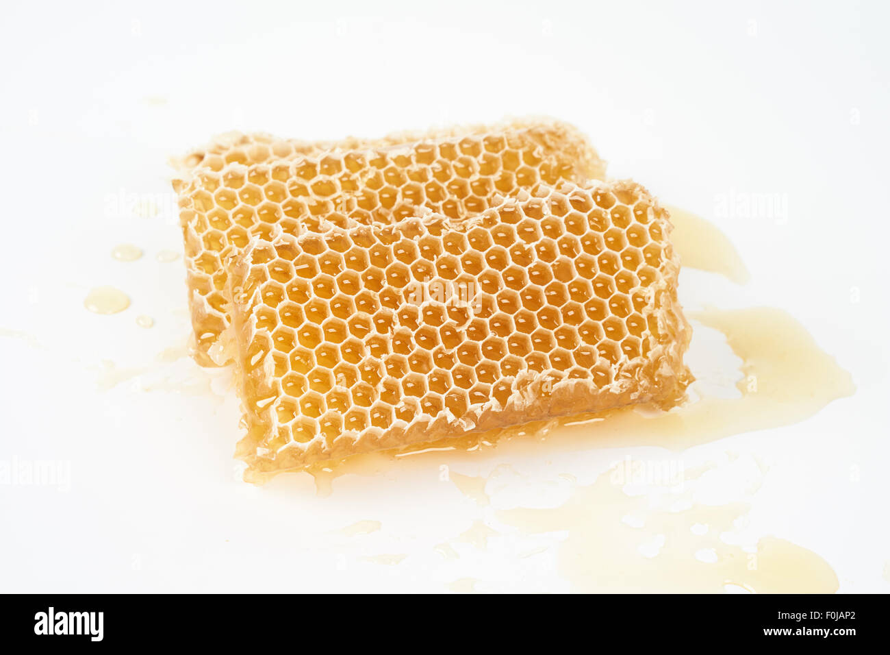 Slices of raw honeycomb placed on white background Stock Photo - Alamy