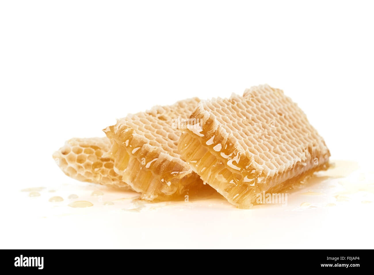 Three slices of honeycomb isolated on white Stock Photo - Alamy