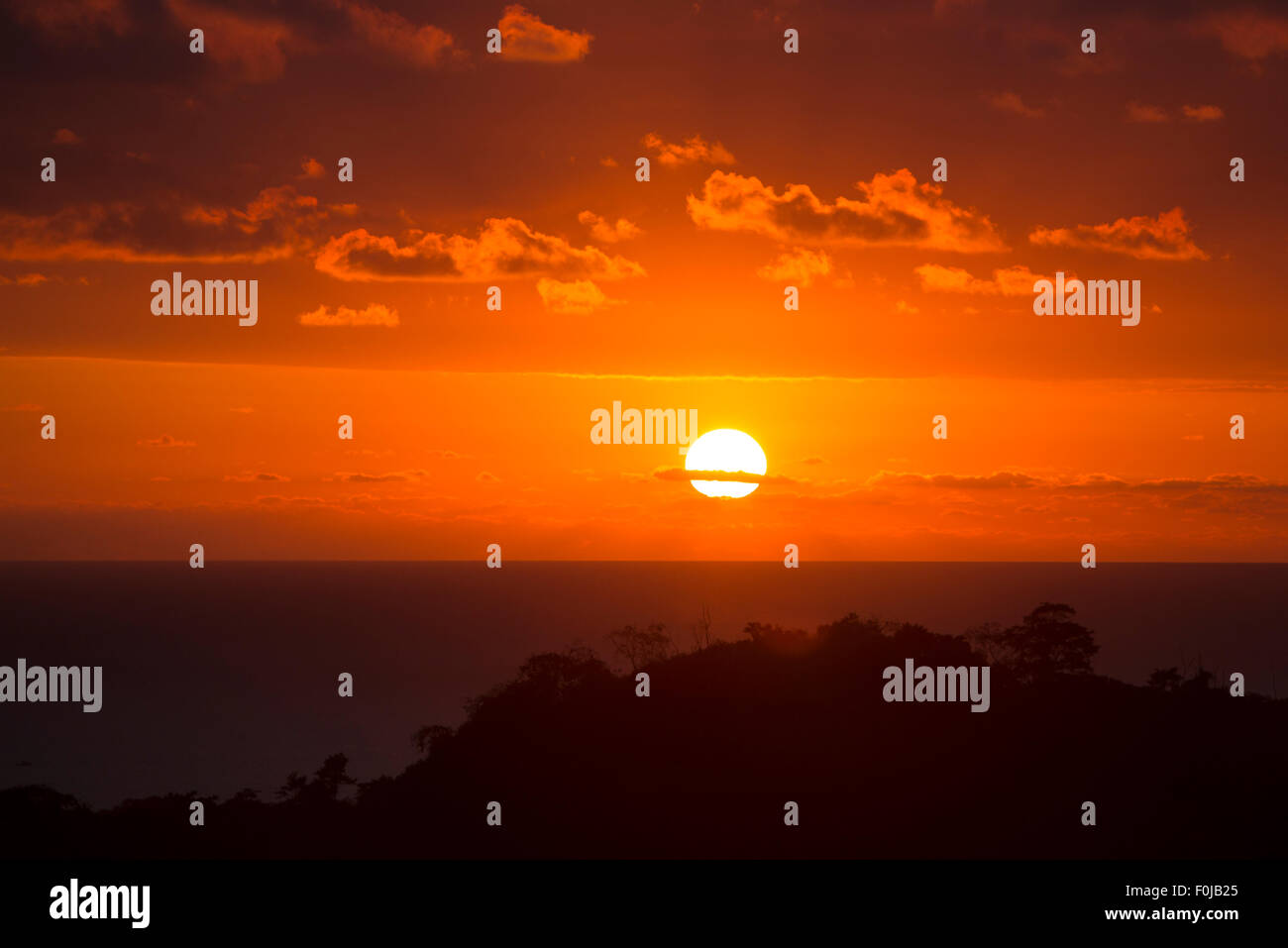 Sunset over Costa Rica. Sun reaching ocean through the clouds, Matapalo ...