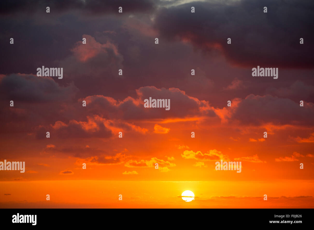 Dramatic sunset sun in clouds seen from the beach of Matapalo, Costa ...