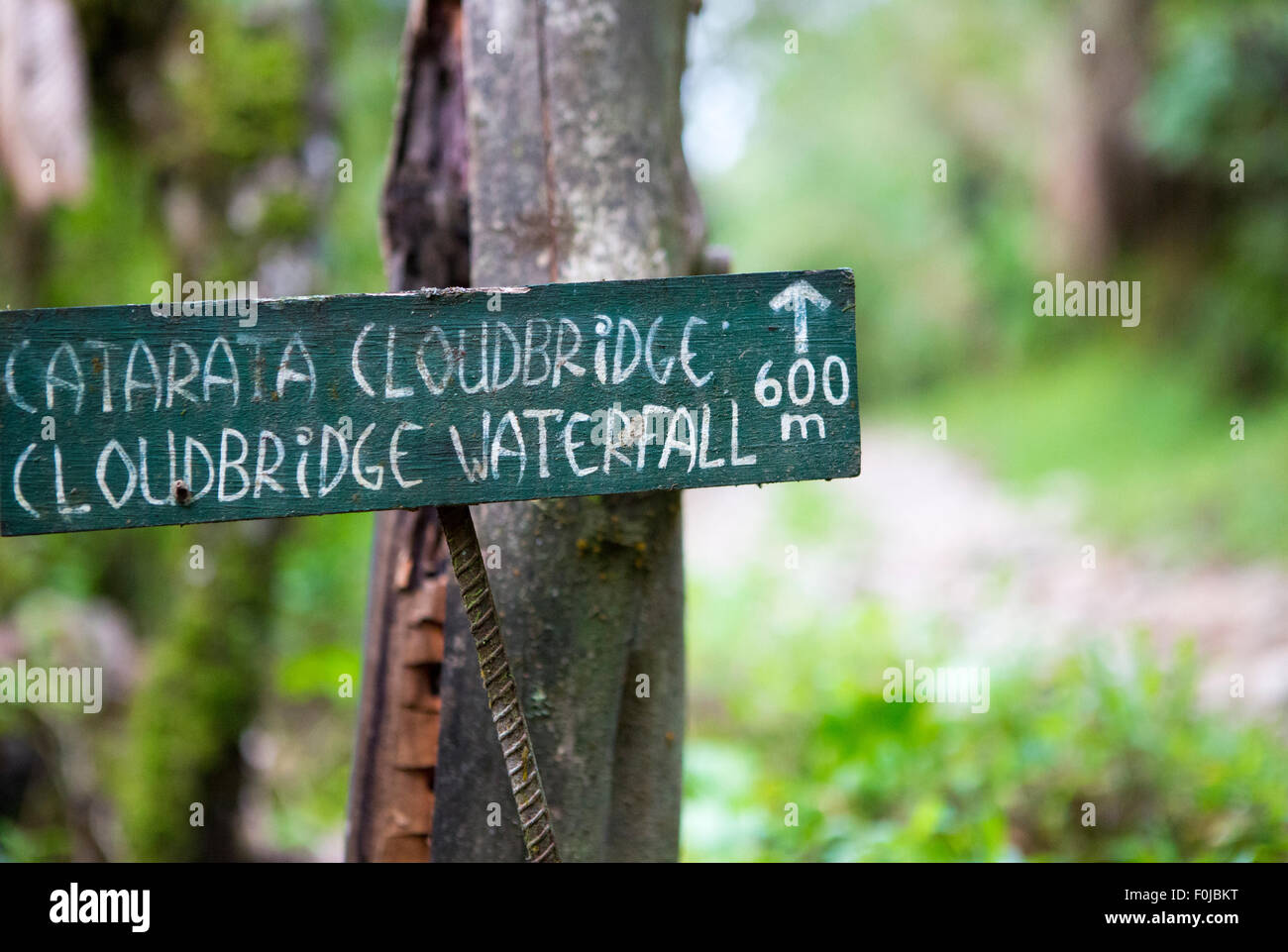 Cloudbridge waterfall sign on a metal post in the forest close by the ...