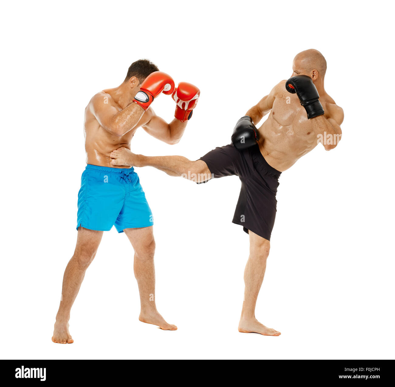 Two kickbox fighters sparring, full length isolated on white background ...