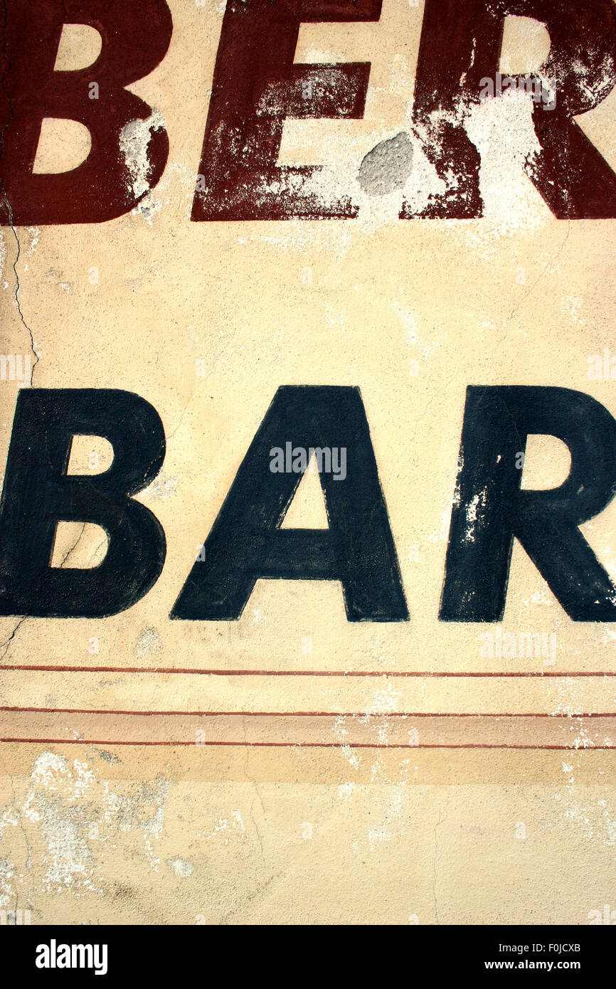 Sign on yellowish old wall with letters saying bar Stock Photo - Alamy