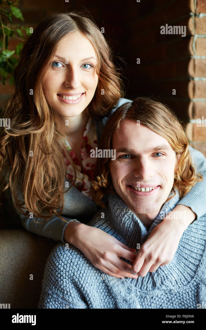 Romantic couple looking at camera with smiles Stock Photo - Alamy