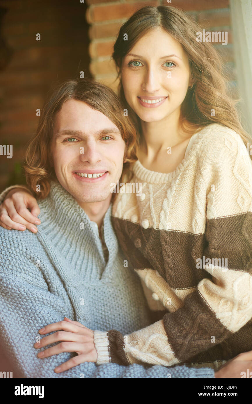 Romantic couple in sweaters looking at camera Stock Photo - Alamy