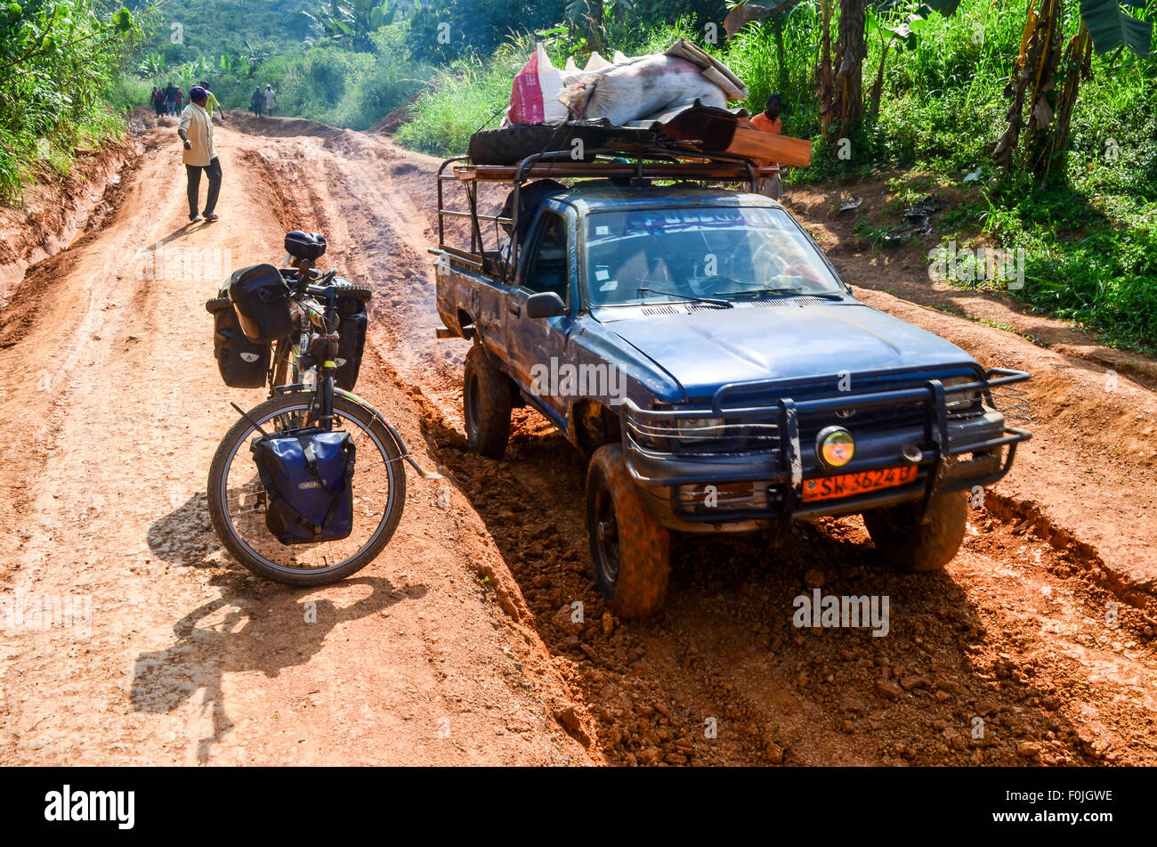 Taxi and bicycle on a dirt road in Cameroon Stock Photo - Alamy