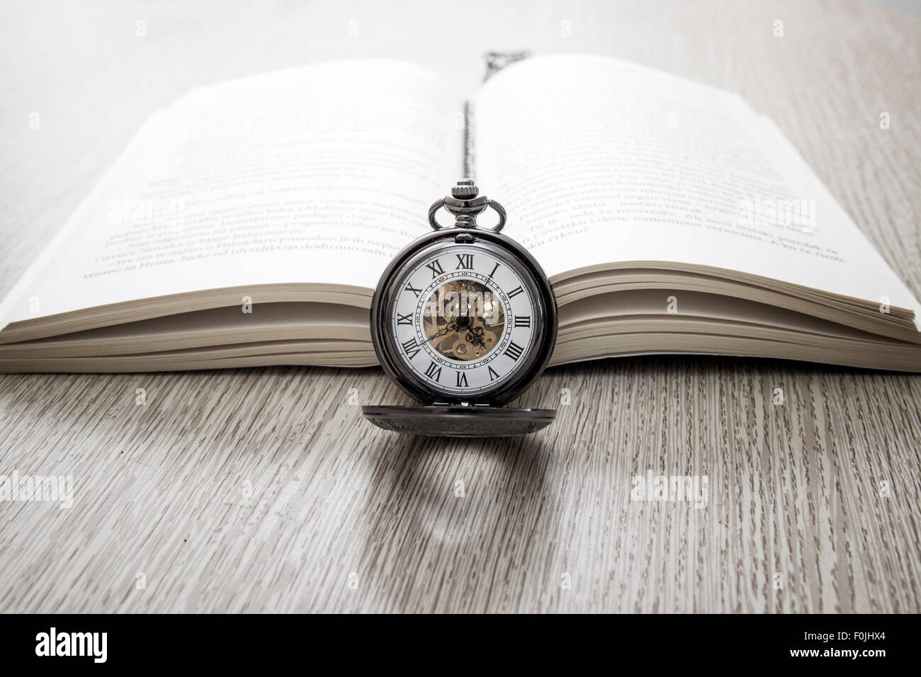 Old pocket watch and book on table, close up Stock Photo - Alamy