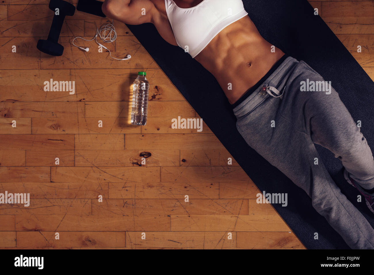Cropped shot of woman relaxing after exercise session with a water ...