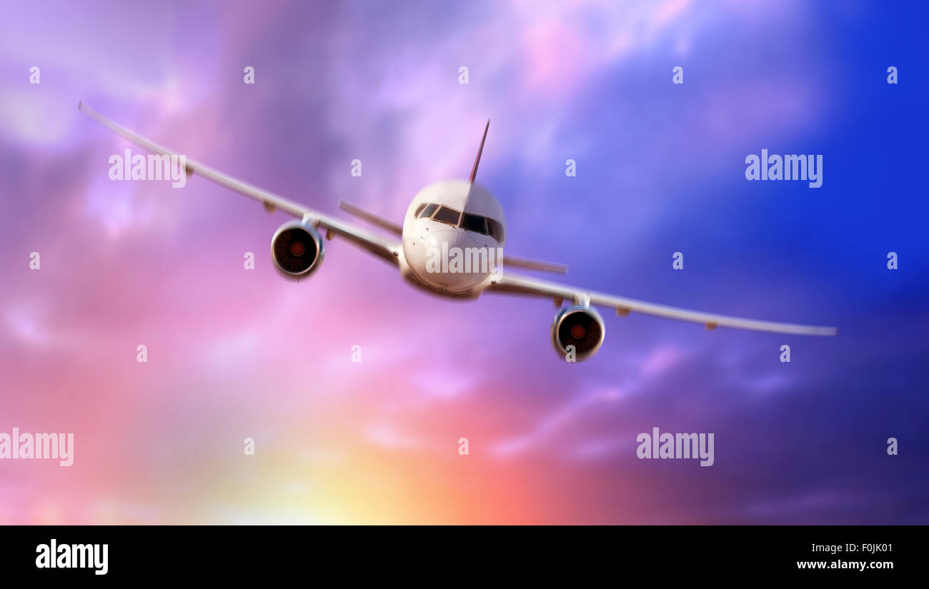 Passenger Airliner flying in the clouds Stock Photo - Alamy