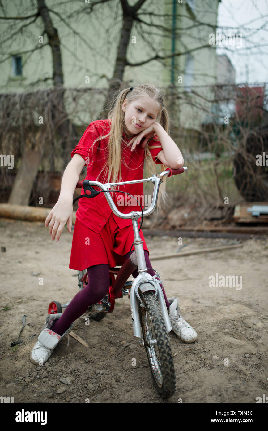children ride on bicycle in yard Stock Photo - Alamy