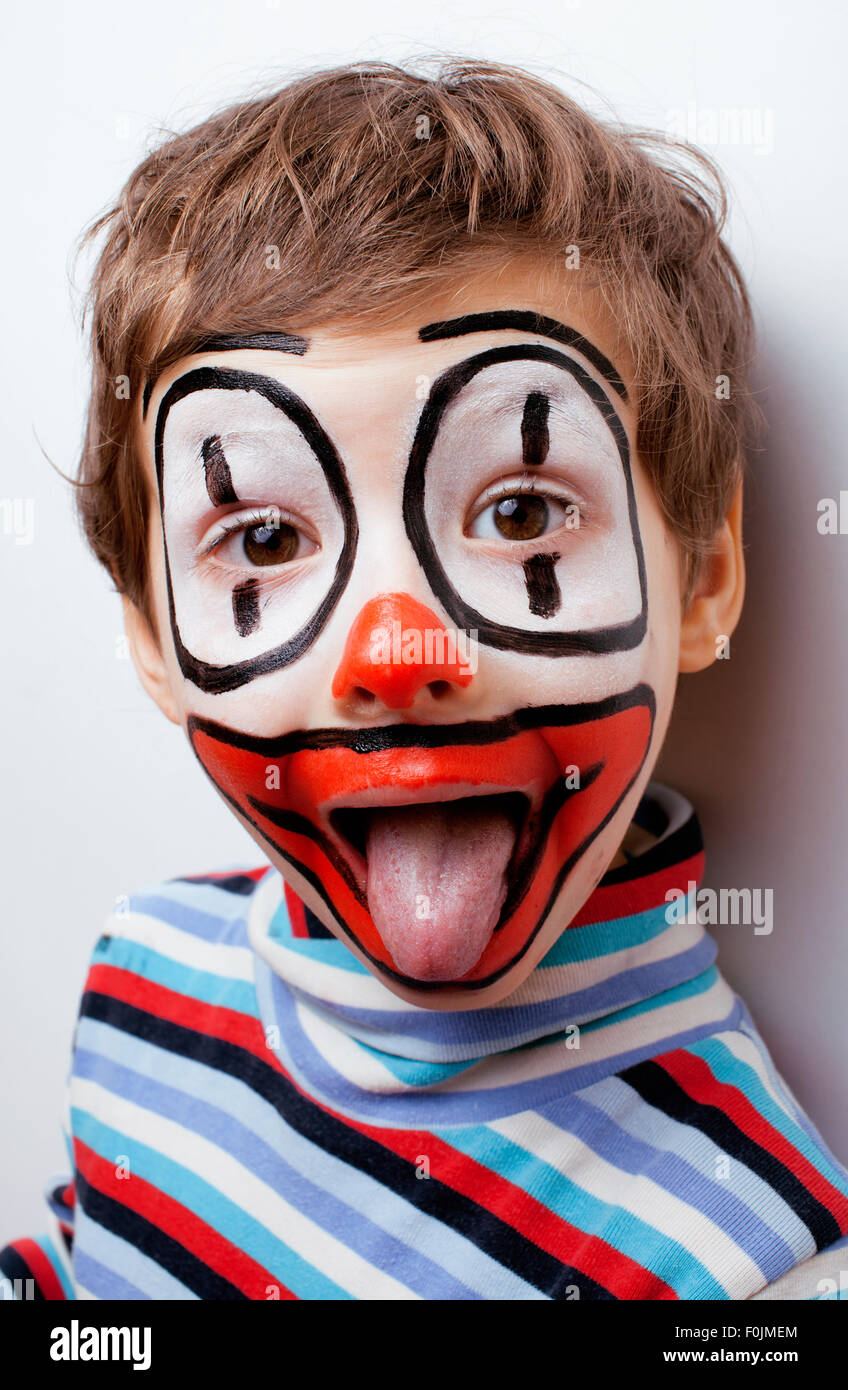 little cute boy with facepaint like clown, pantomimic expressions close ...