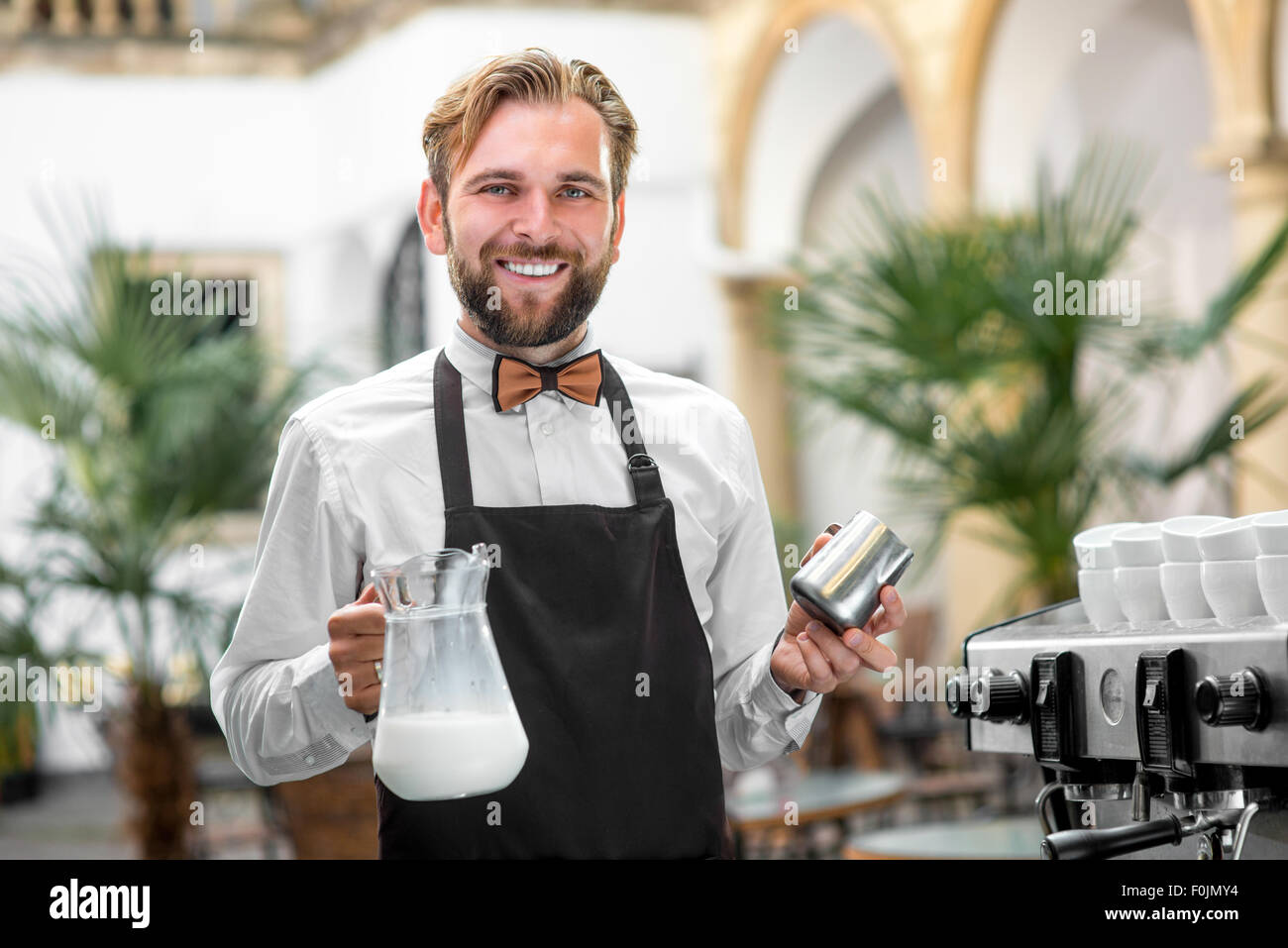 Positive young bearded male barista hi-res stock photography and images ...