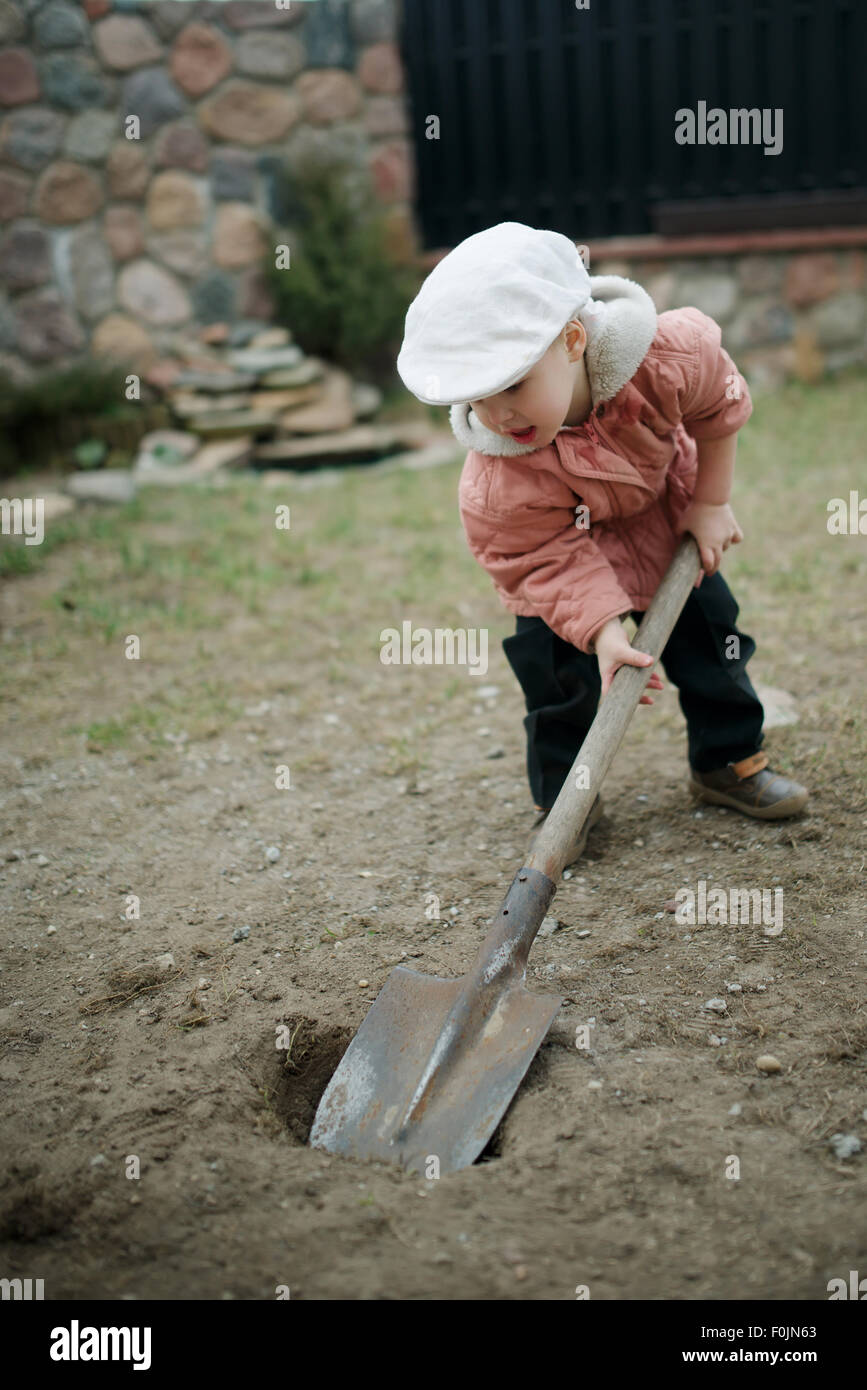 little boy digging a hole Stock Photo - Alamy