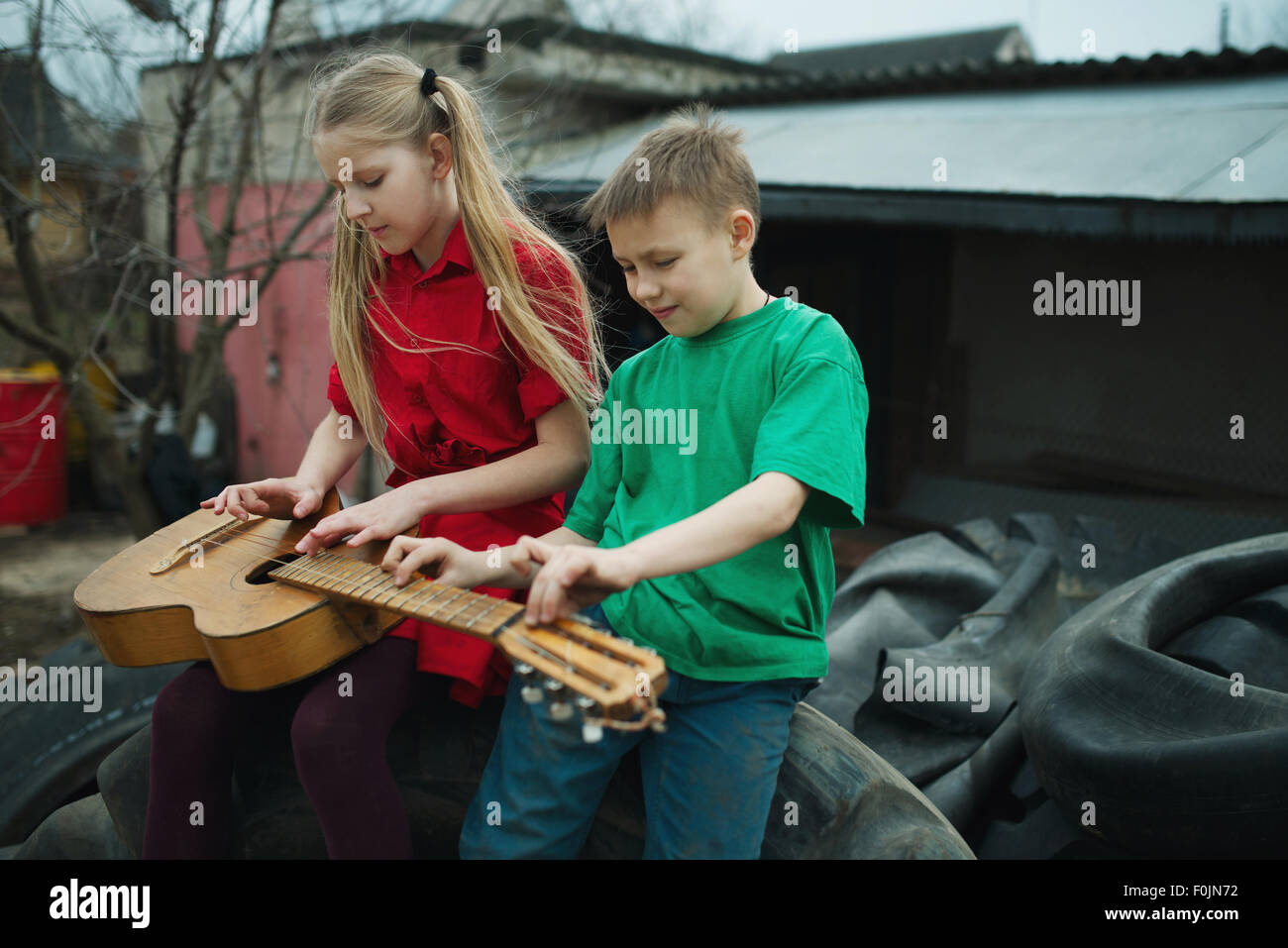 children learn to play the guitar Stock Photo - Alamy