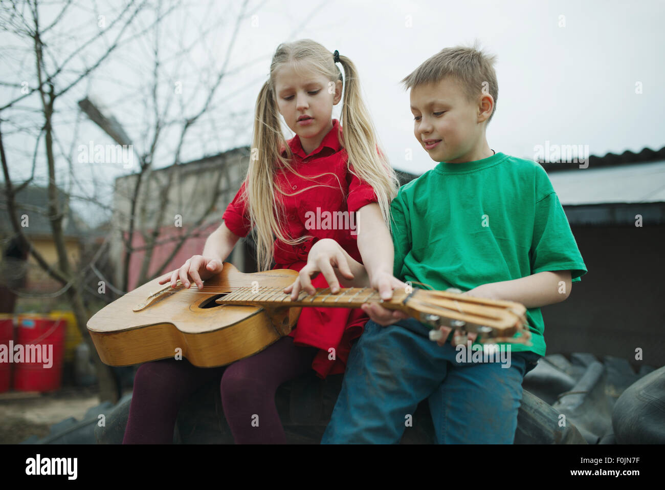 children learn to play the guitar Stock Photo - Alamy