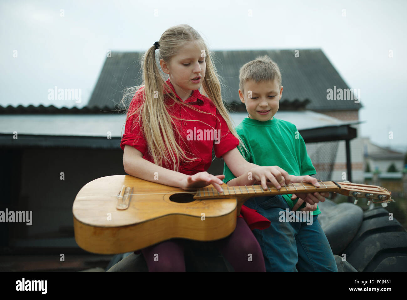 children learn to play the guitar Stock Photo - Alamy