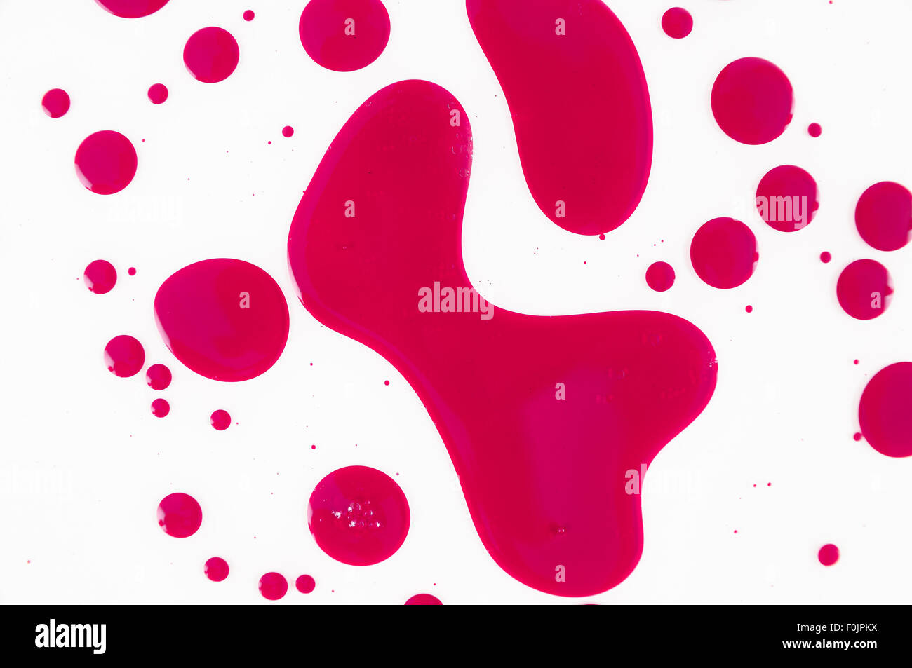 Magenta ink spots in oil Stock Photo - Alamy