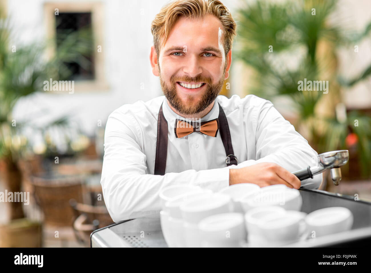 Positive young bearded male barista hi-res stock photography and images ...