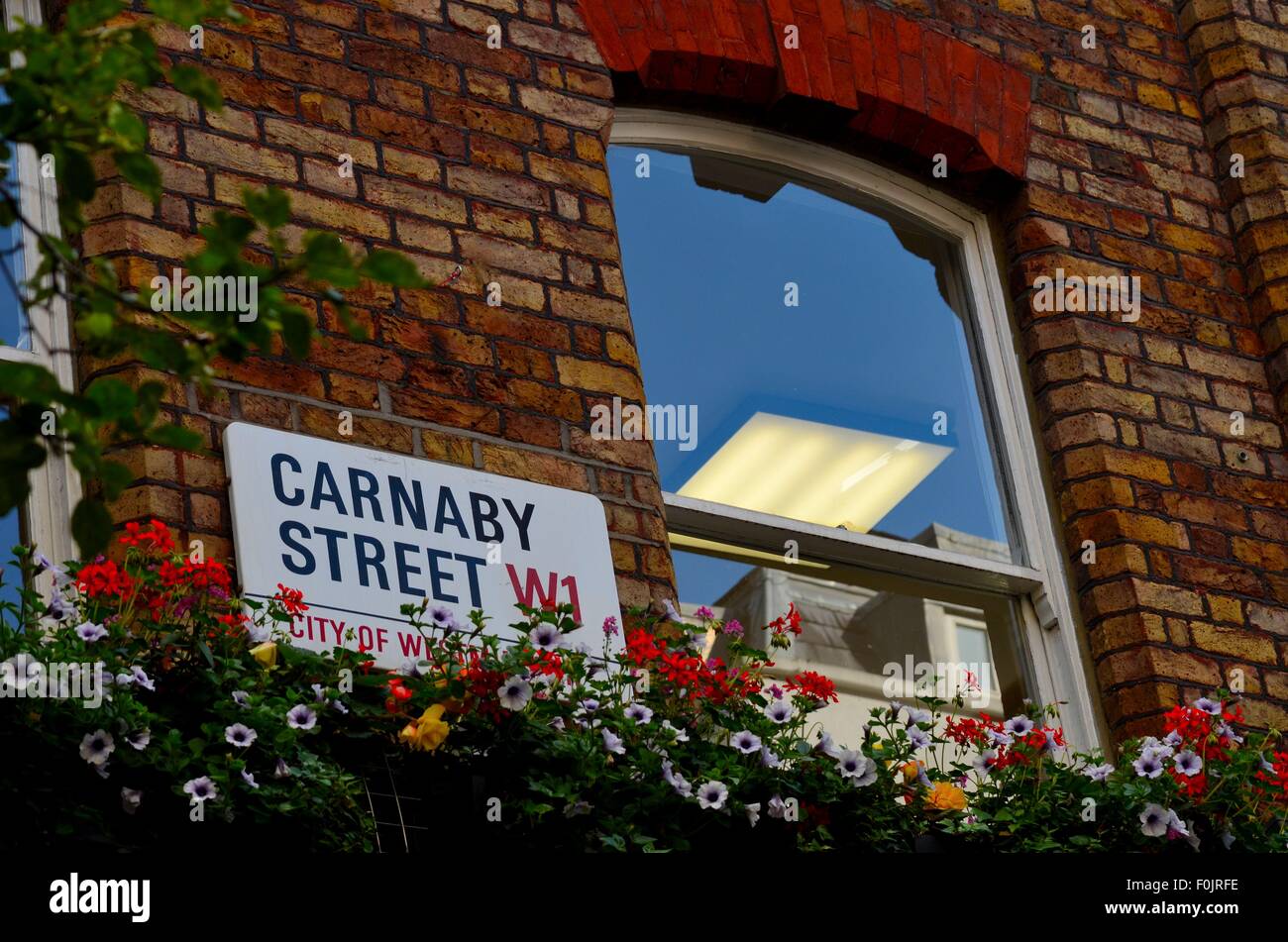 Carnaby Street sign with window and potted flowers London England Stock ...