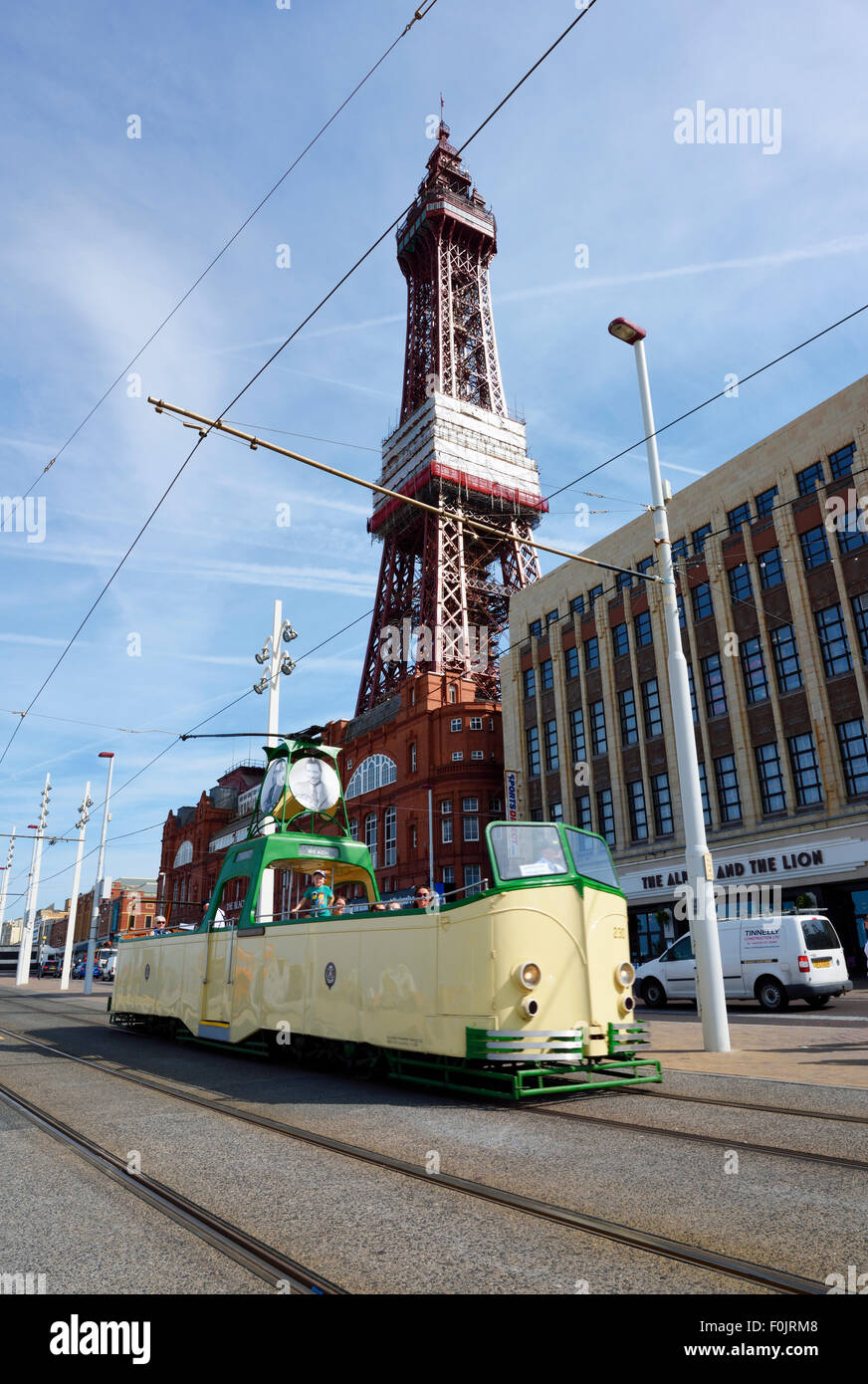 Open topped heritage tram passes in front of the iconic Blackpool Tower ...
