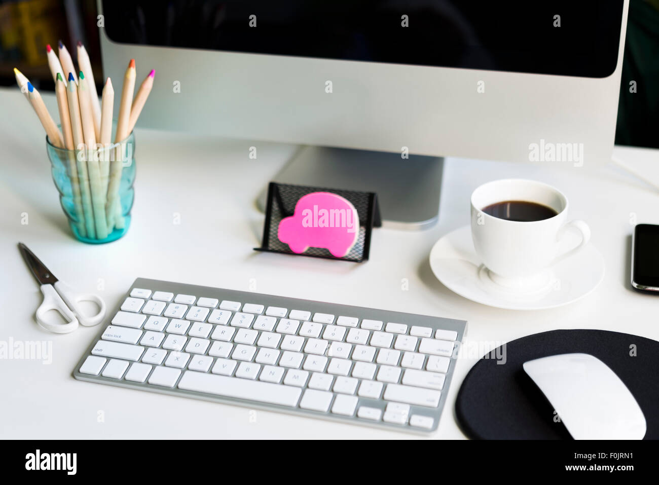 Office workplace with computer on white table. Focus on keyboard Stock ...