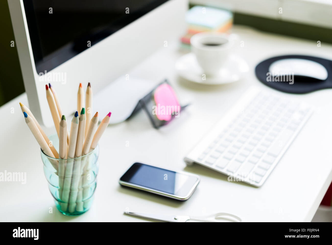 Office workplace with computer on white table. Focus on pencils Stock ...
