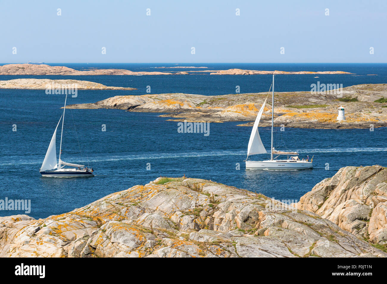 Sailboats in rocky coastal scenery Stock Photo - Alamy