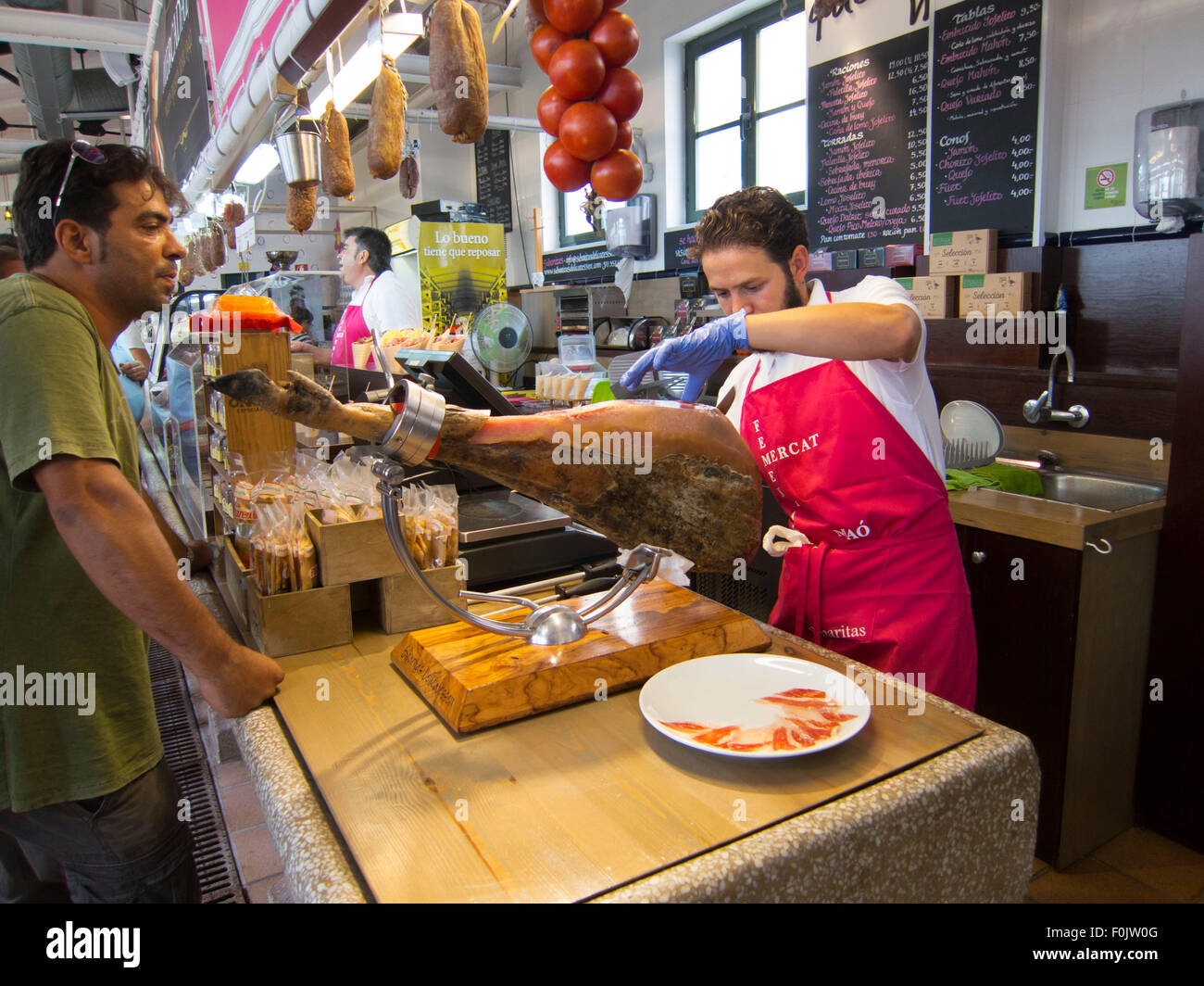 Man carving Iberico ham Stock Photo - Alamy